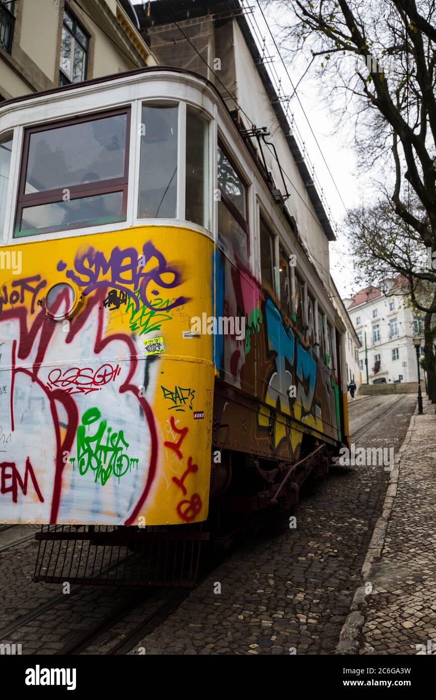 One of Lisbon's trams covered in graffiti Stock Photo - Alamy