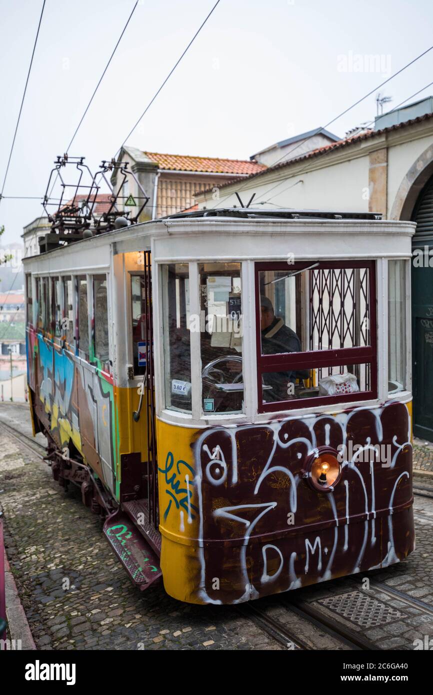 One of Lisbon's trams covered in graffiti Stock Photo - Alamy