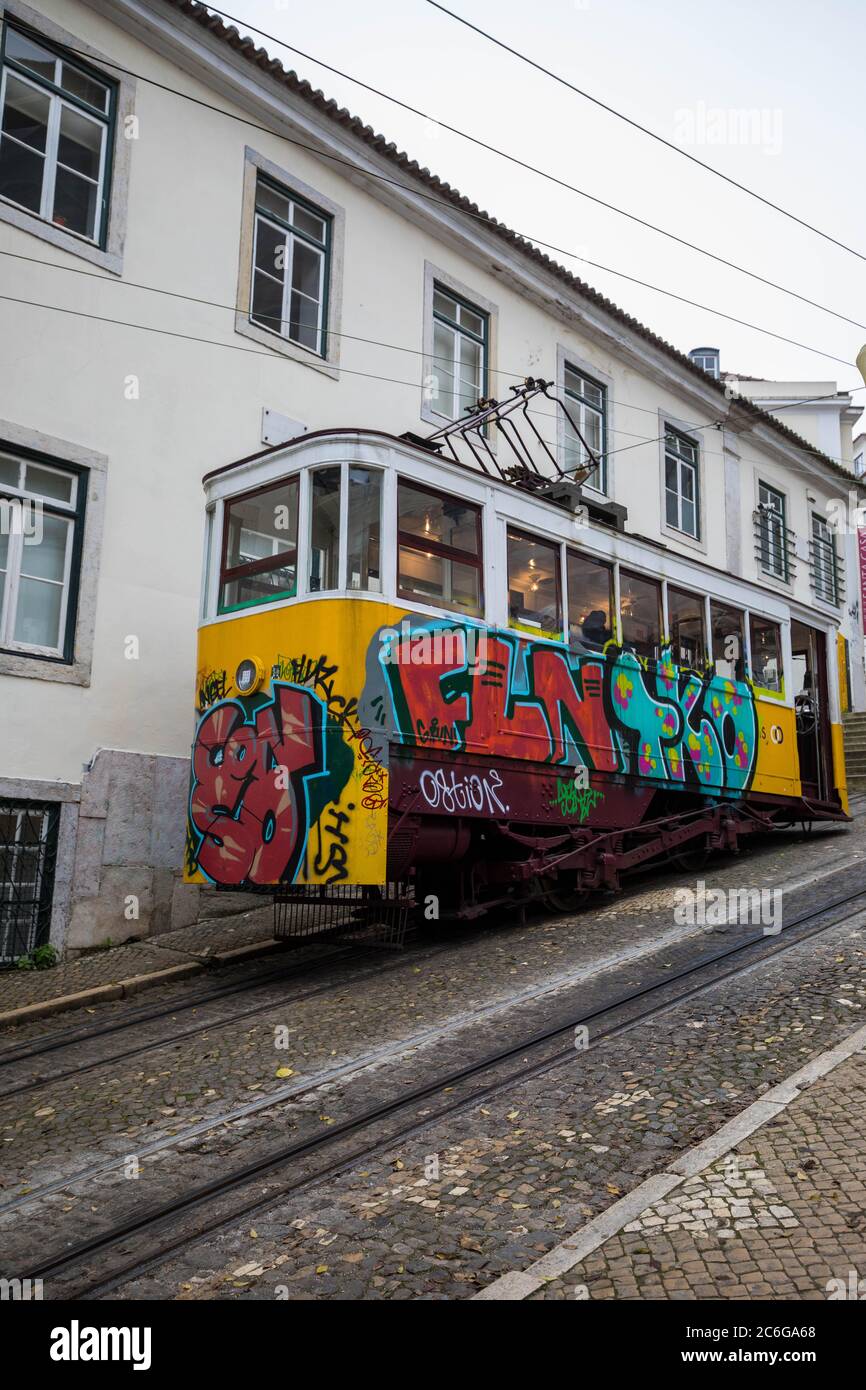 One of Lisbon's trams covered in graffiti Stock Photo - Alamy