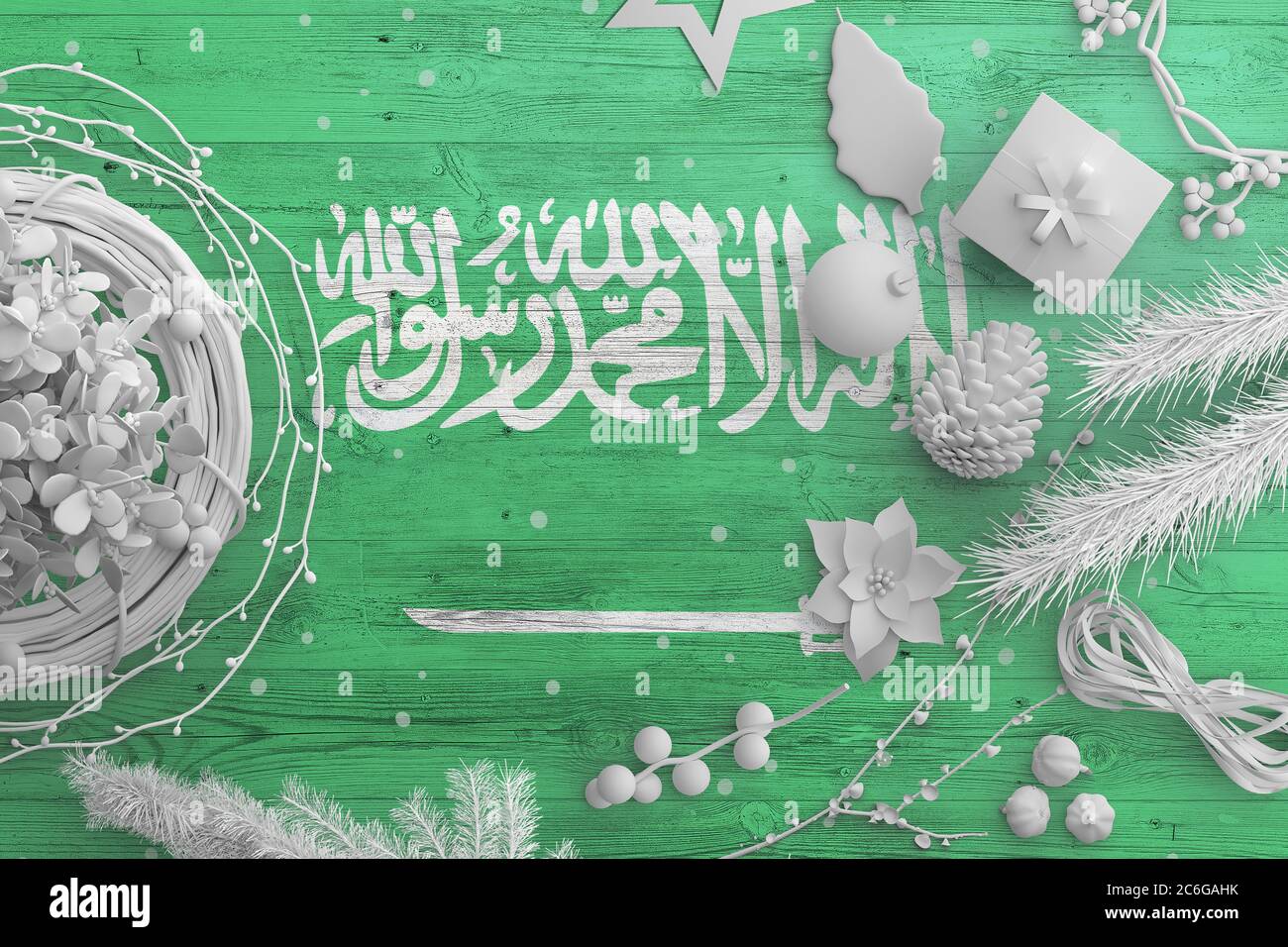 Saudi Arabia flag on wooden table with snow objects. Christmas and new ...