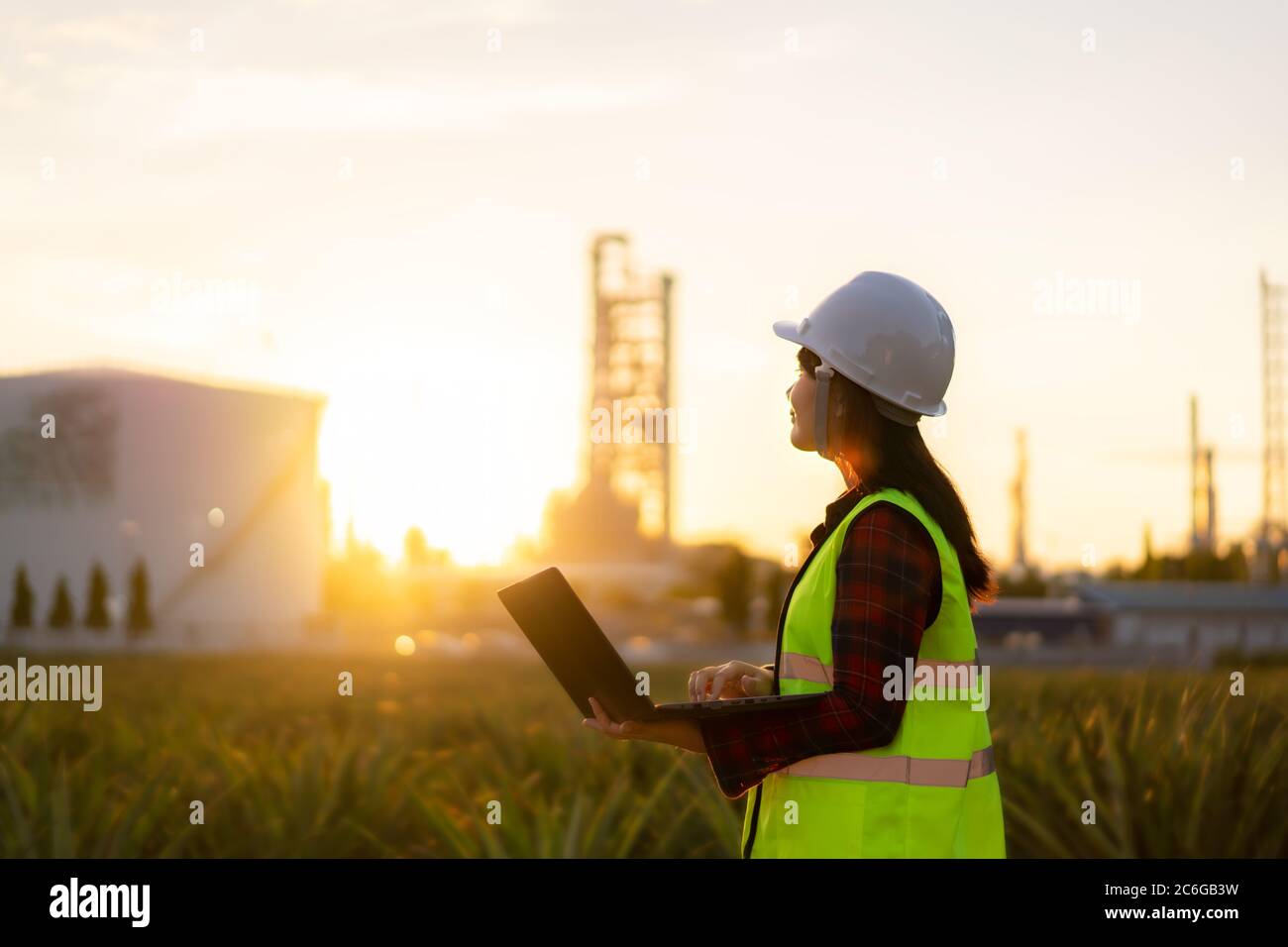 Asian woman petrochemical engineer working at night with laptop Inside ...