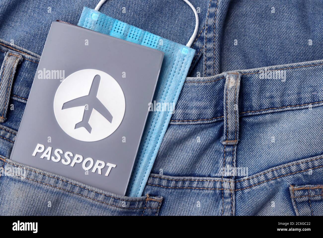 Passport with medical mask in jeans back pocket background with copy ...