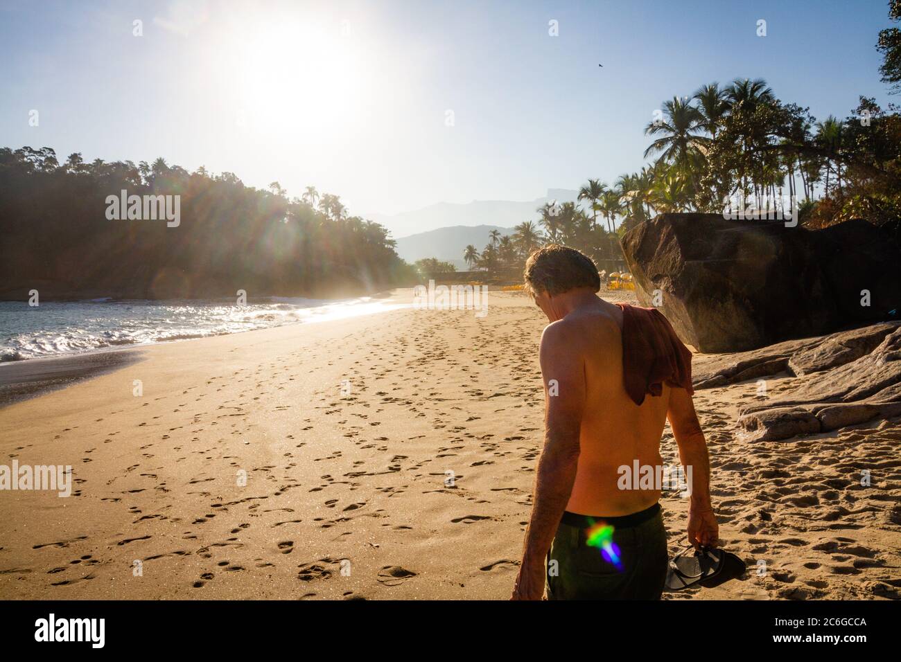 Man on beach during sunset hi-res stock photography and images - Alamy