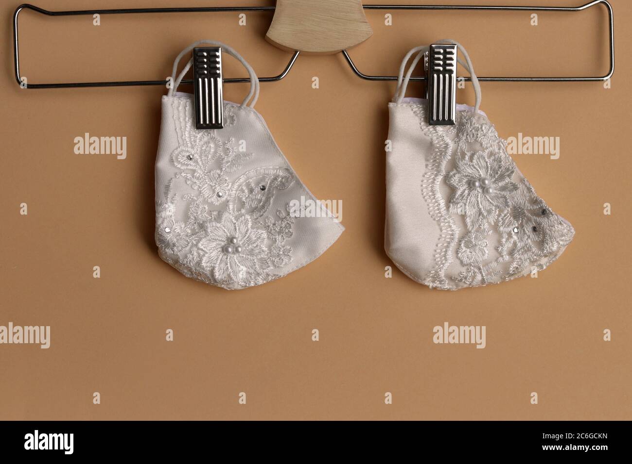 White color of lace reusable face masks hanging on clothes hanger ...