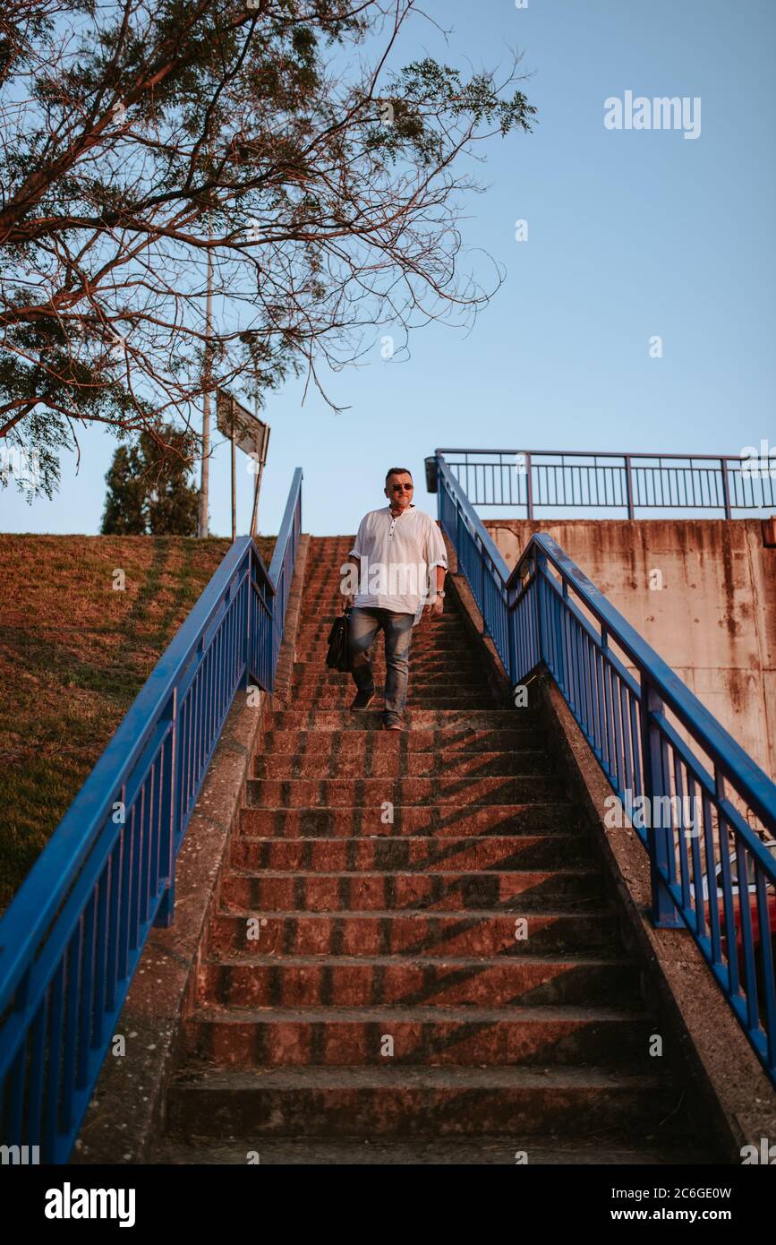 Man goes down stairs hi-res stock photography and images - Alamy