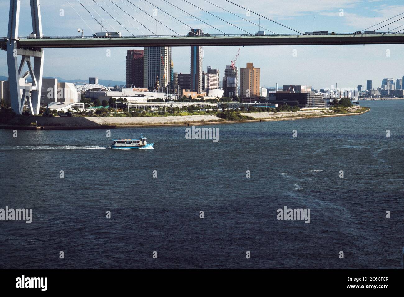 Boat on the water under big bridge, city of Tokyo Japan Stock Photo - Alamy