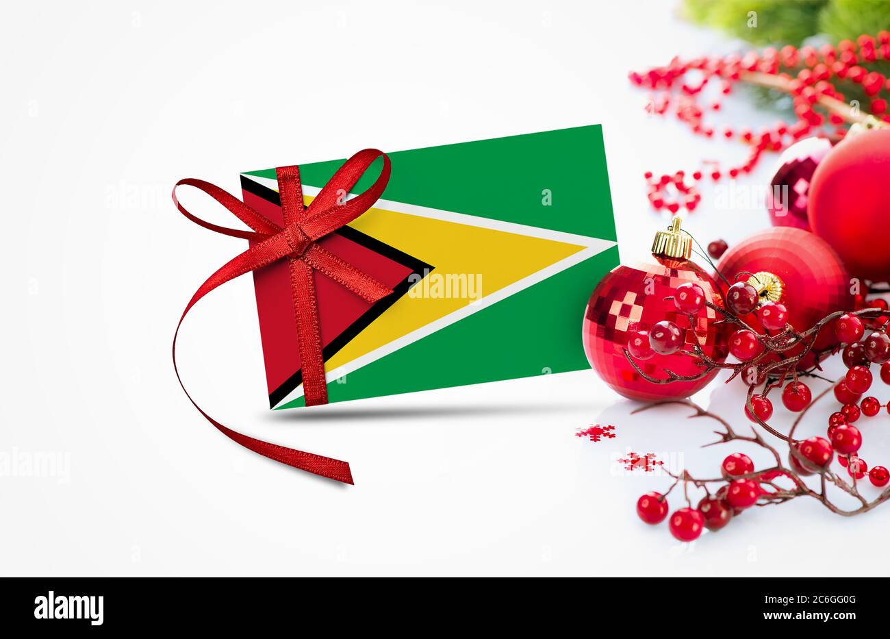 Guyana flag on new year invitation card with red christmas ornaments ...