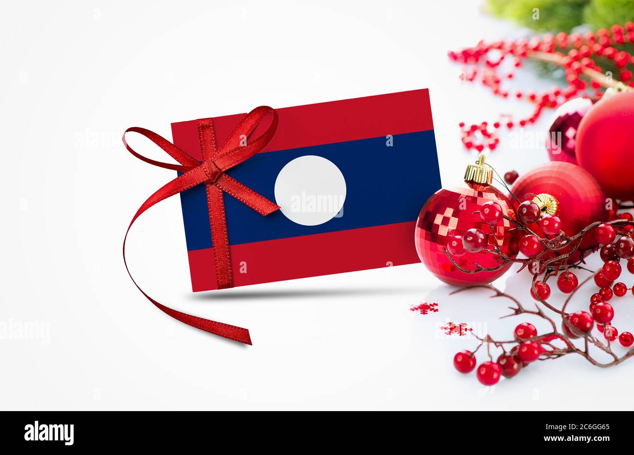 Laos flag on new year invitation card with red christmas ornaments ...