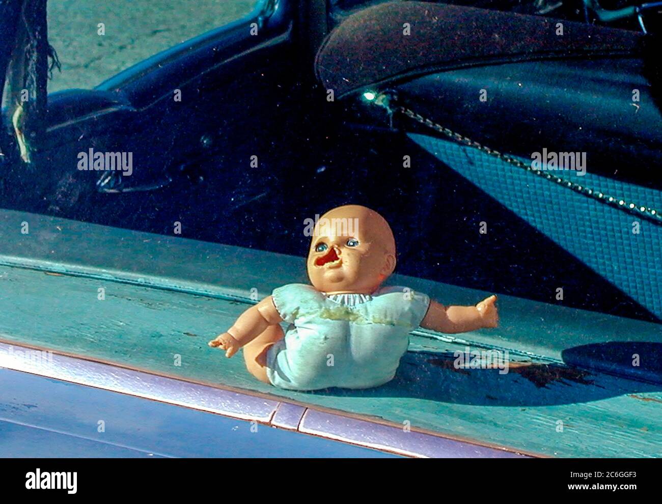 Strange doll pressed up to the rear window of a parked car Stock Photo ...