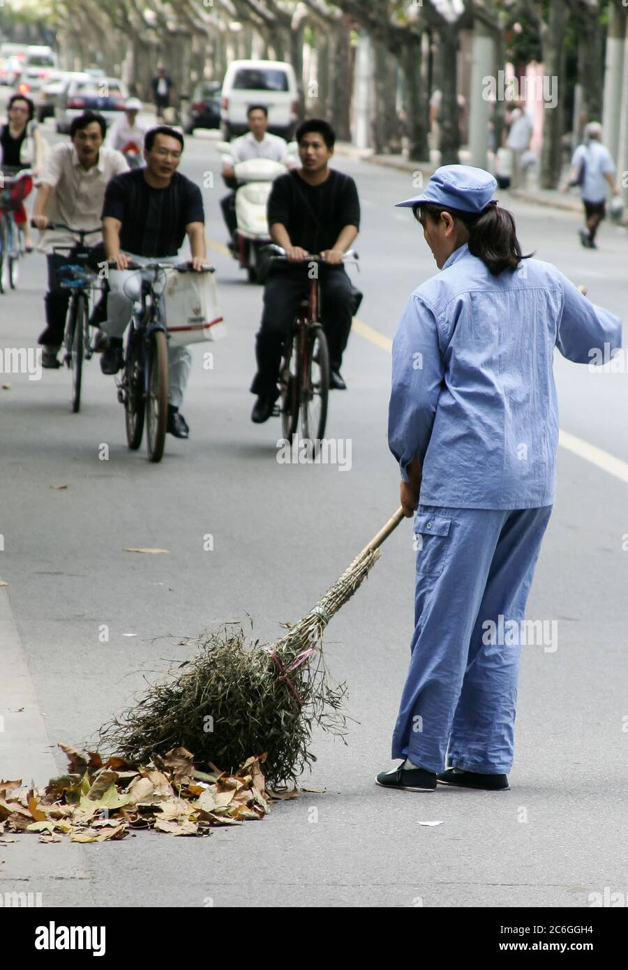Street cleaner clears the road in Shanghai Stock Photo - Alamy