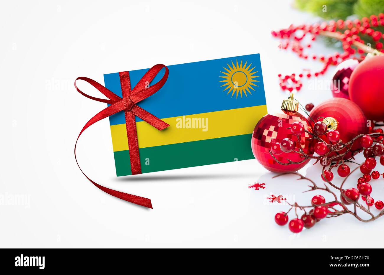 Rwanda flag on new year invitation card with red christmas ornaments ...