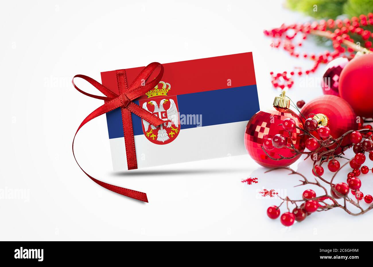Serbia flag on new year invitation card with red christmas ornaments ...