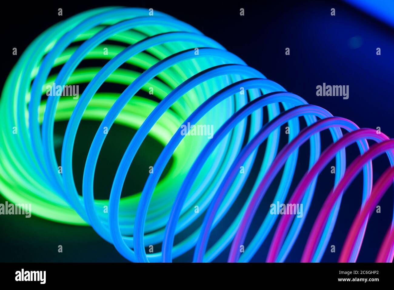 Multi-colored circular spiral objects are viewed in close and lit with ...
