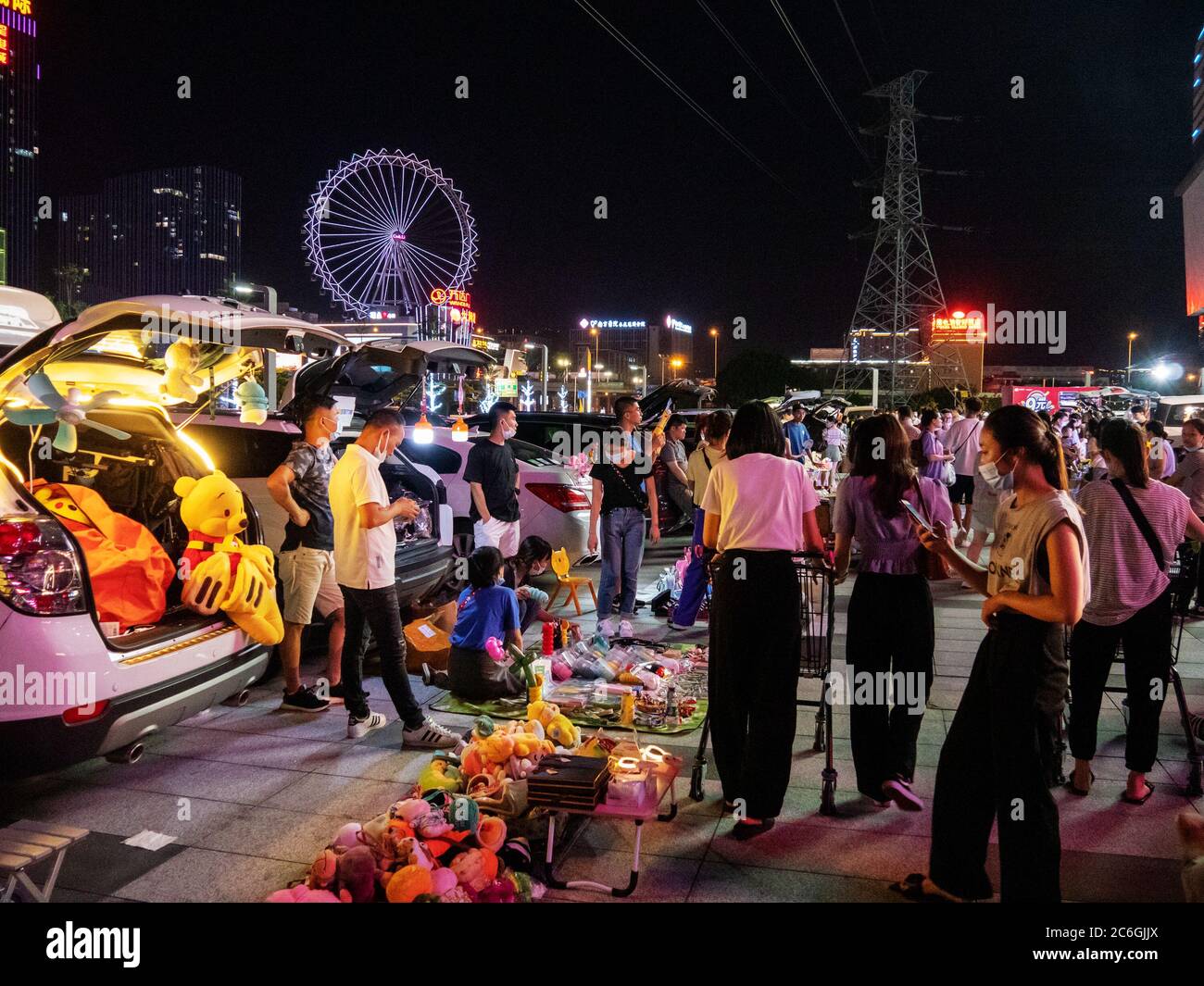 People walk and shop around at a 7-day temporary night market in ...