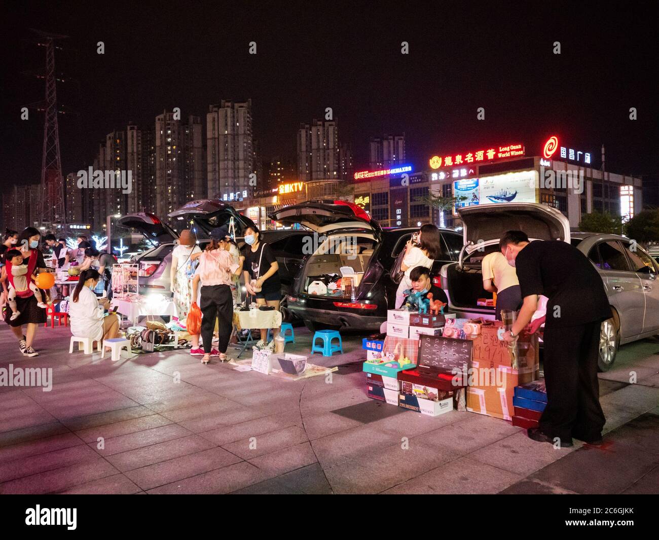 People walk and shop around at a 7-day temporary night market in ...