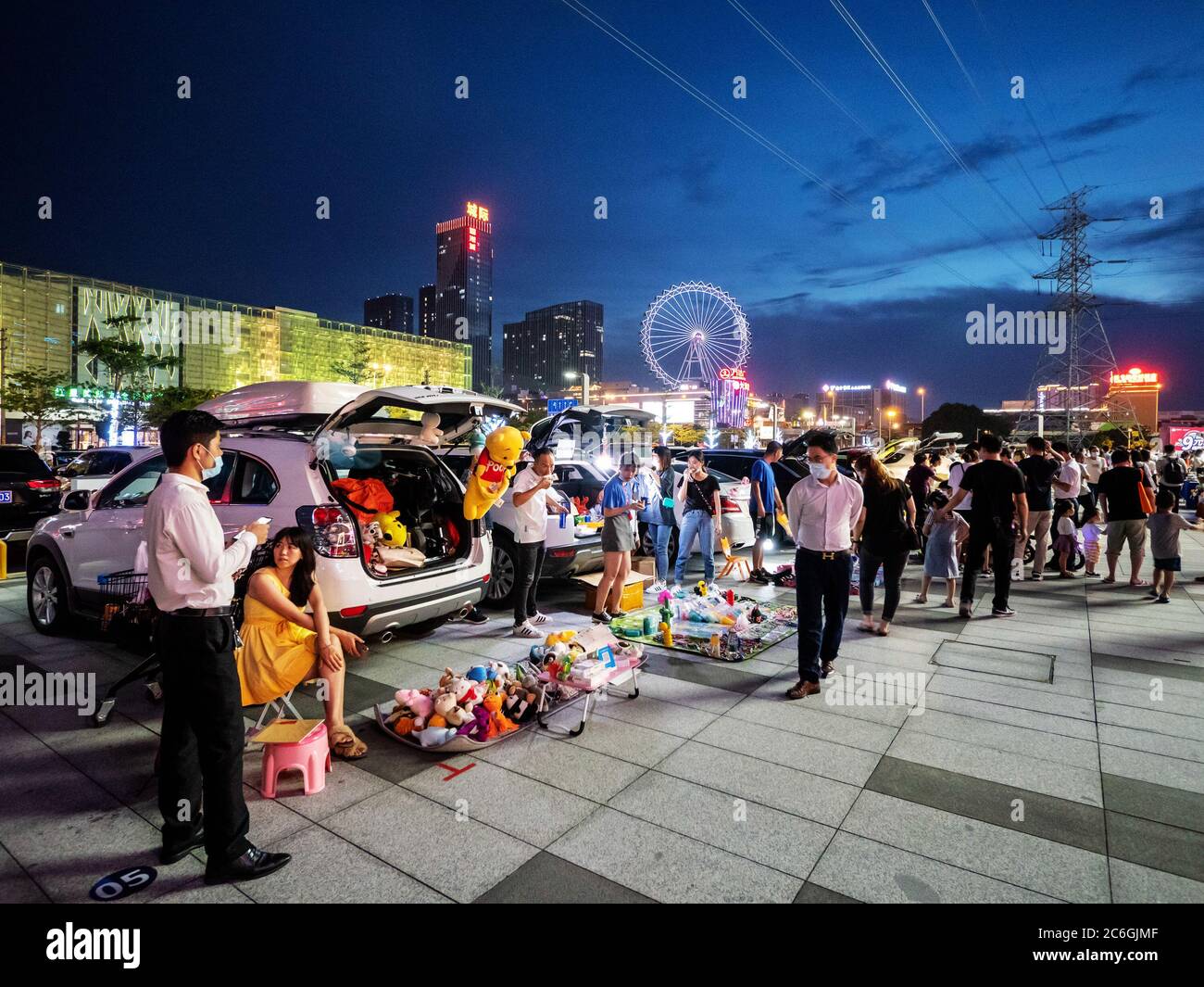 People walk and shop around at a 7-day temporary night market in ...