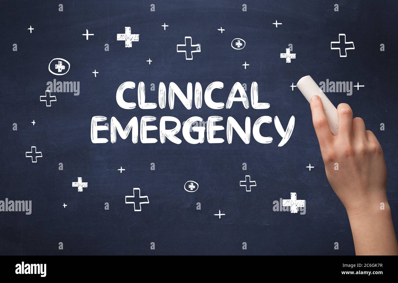 Hand drawing CLINICAL EMERGENCY inscription with white chalk on ...