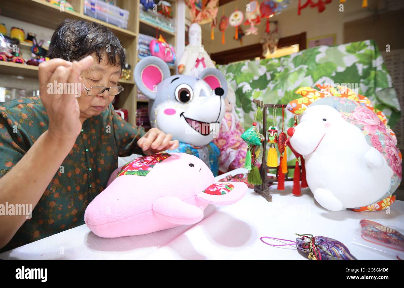 Ms. Wei shows one of her sewing piece at her living room in Xi'an city ...