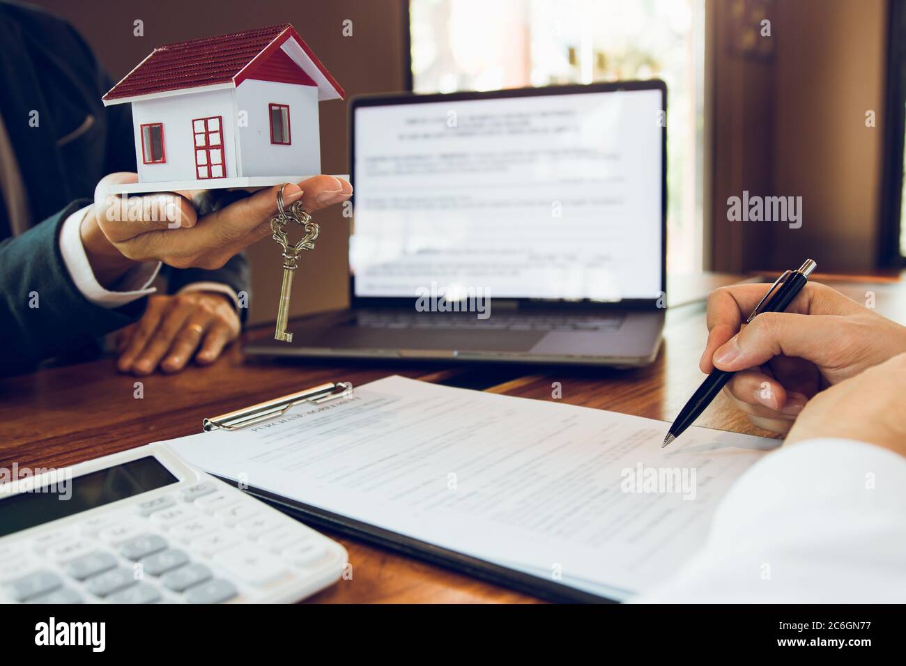 Customer writing signing signature on paper contract with real estate ...