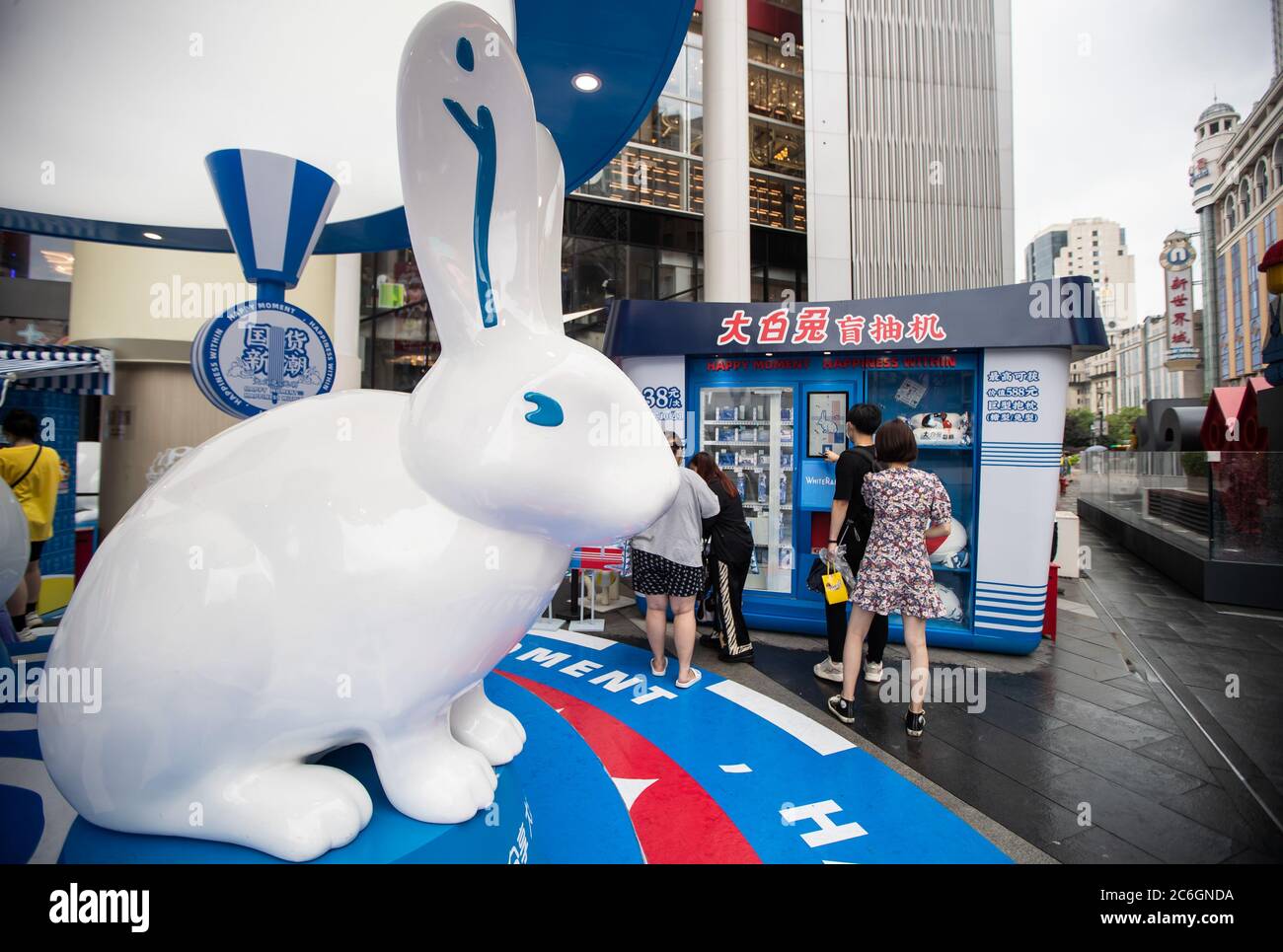 People line up to get a blind box in front of the White Rabbit blind ...
