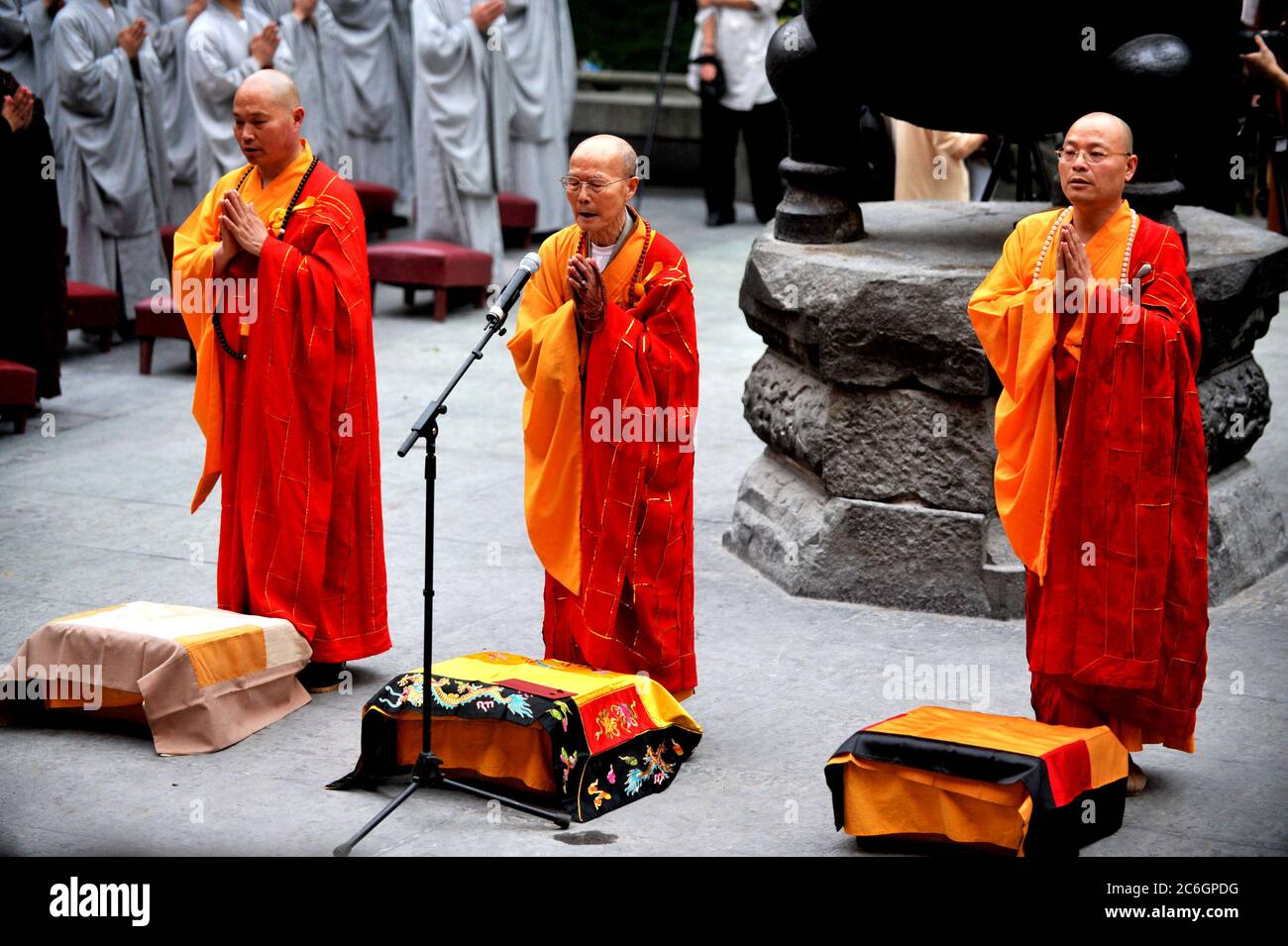 In this undated photo, monks gather and chant scriptures in the yard ...