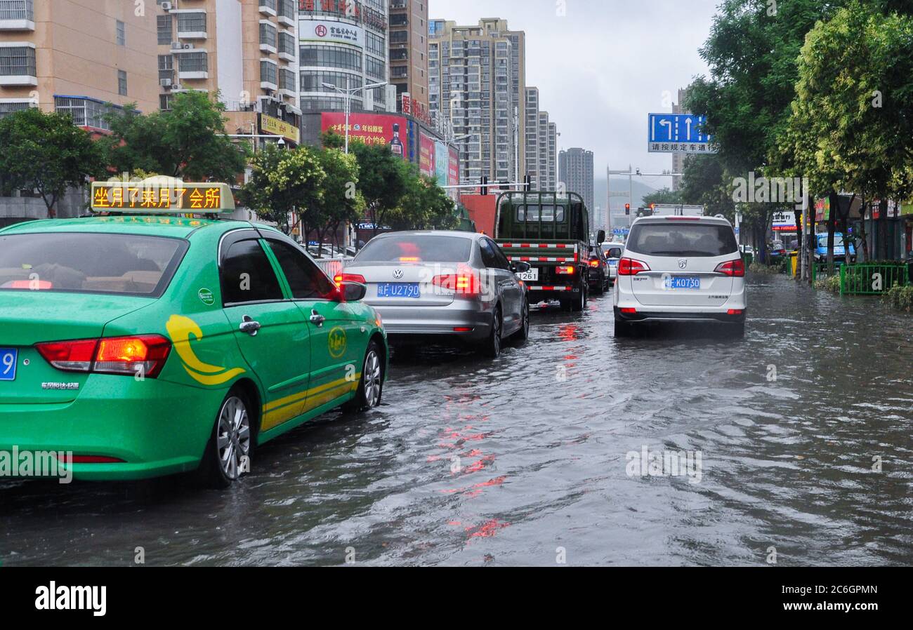 Cars drive through water ponding caused by heavy rain in Huaibei city ...
