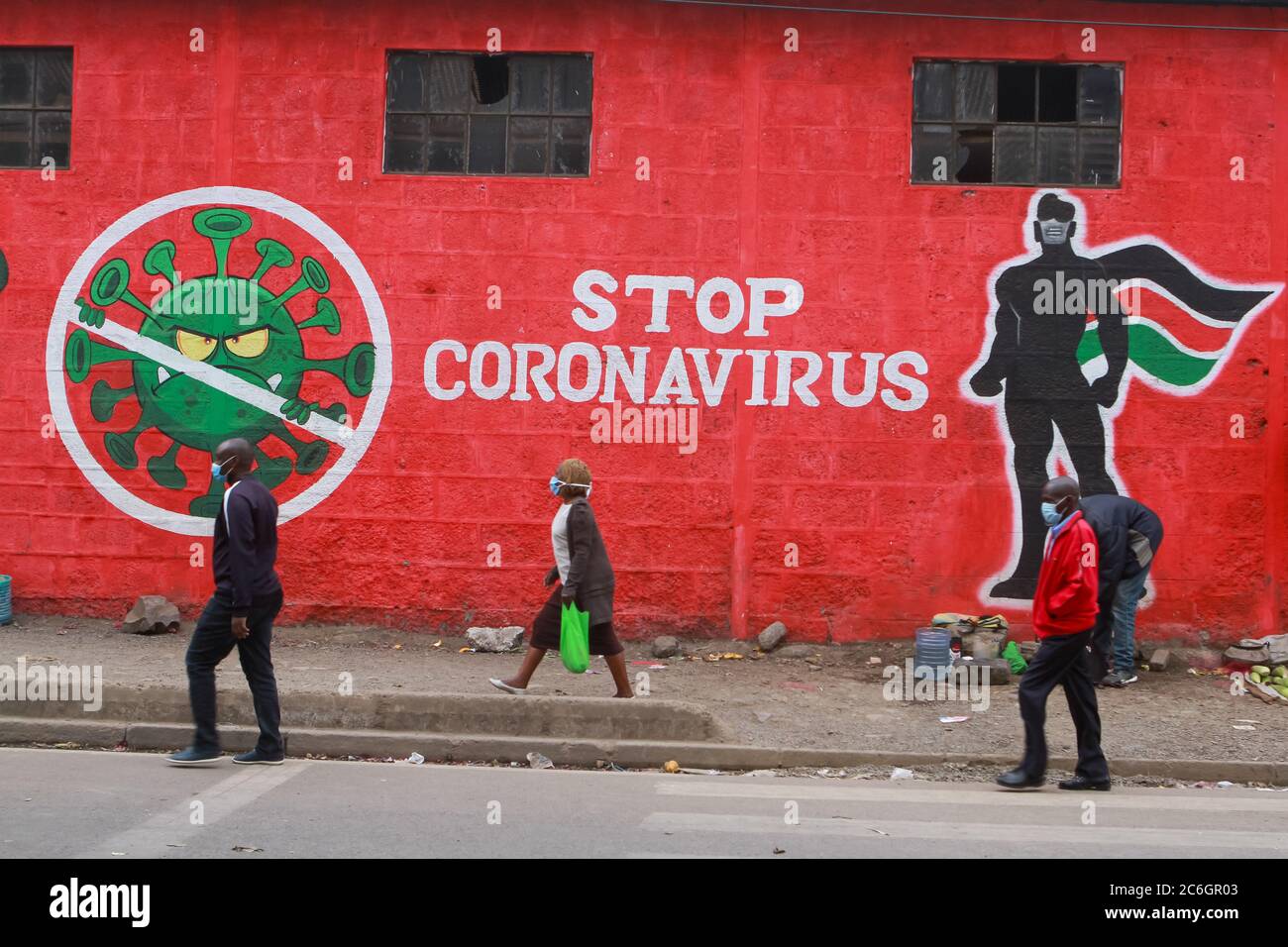 Nairobi, Kenya. 07th July, 2020. Kenyans walk past a mural sensitising ...