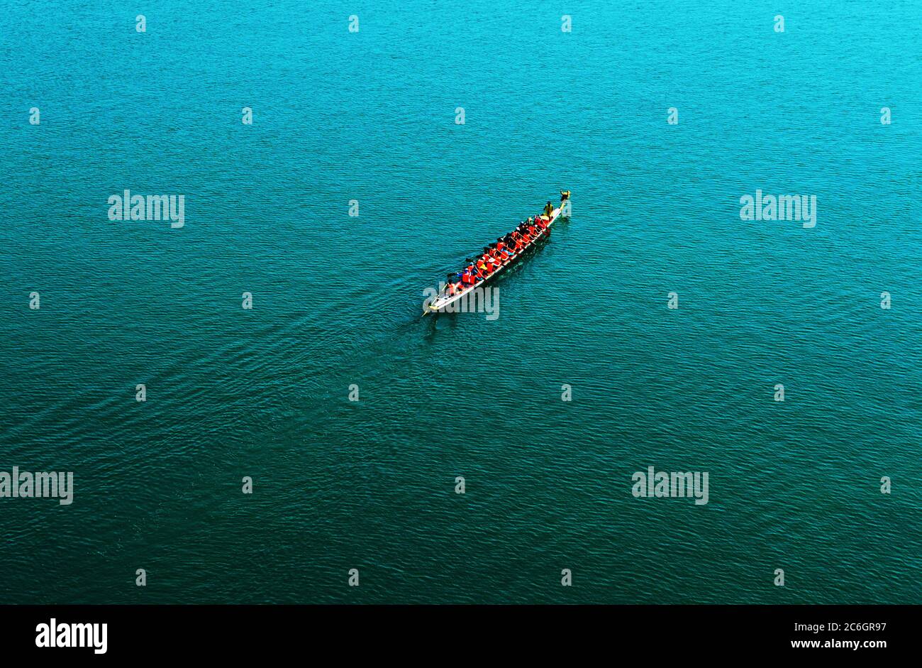 An aerial view of a group of men busy at practicing rowing a dragon ...