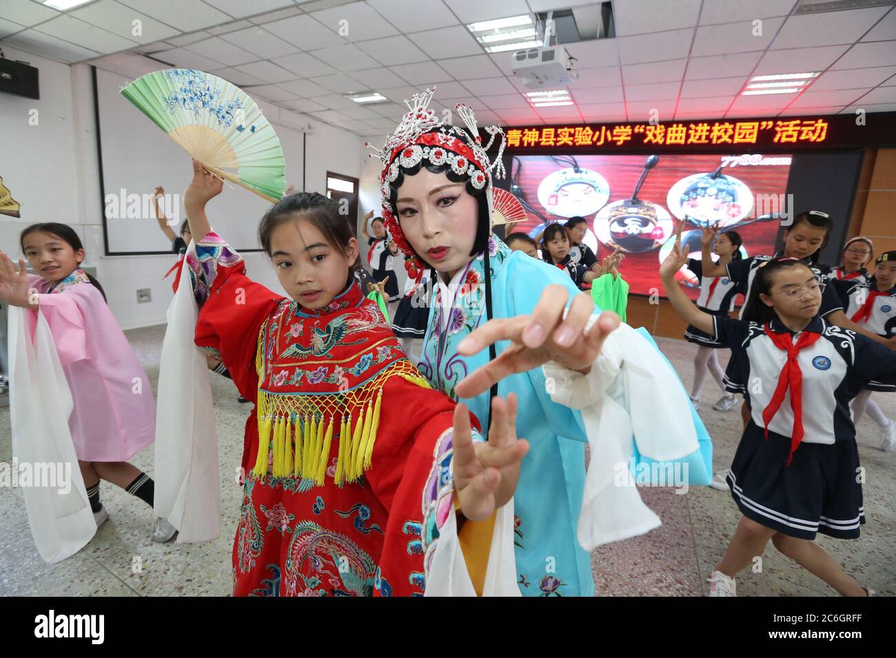 Instructed by a professional Peking Opera actress, local primary school ...