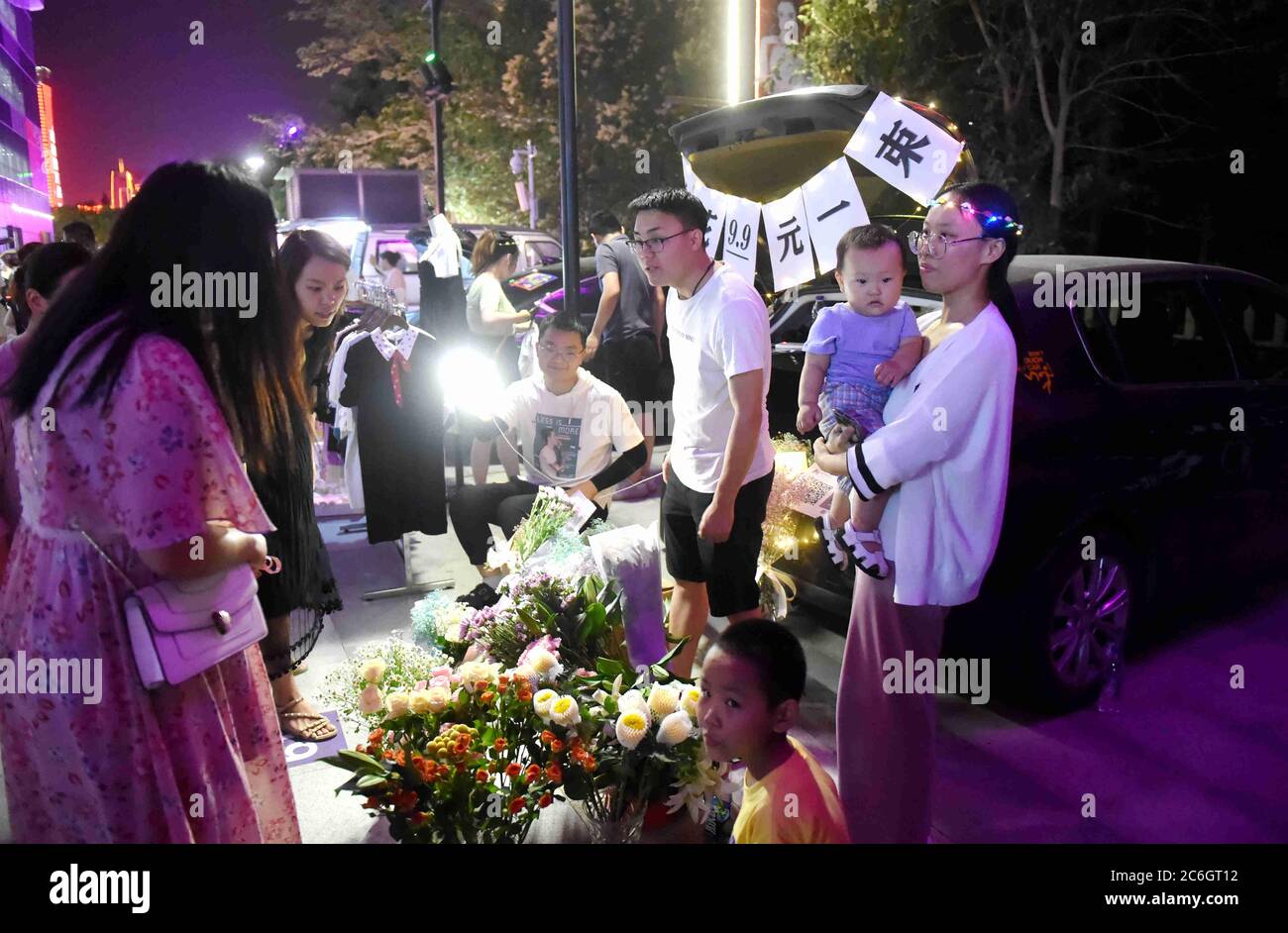 Customers wander and purchase at a trunk bazaar, where limousines ...