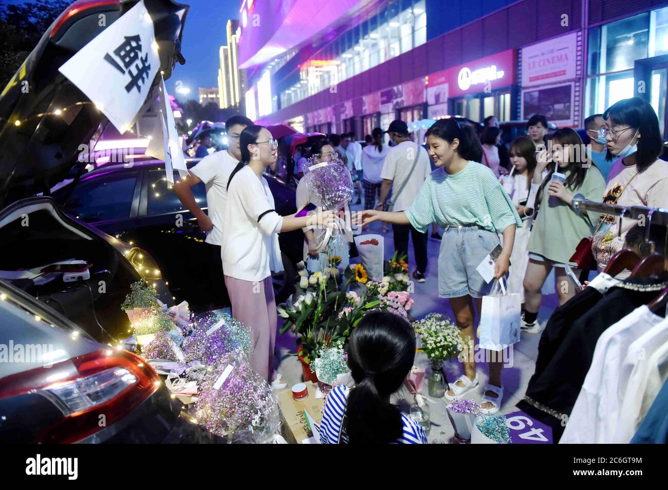 Customers wander and purchase at a trunk bazaar, where limousines ...