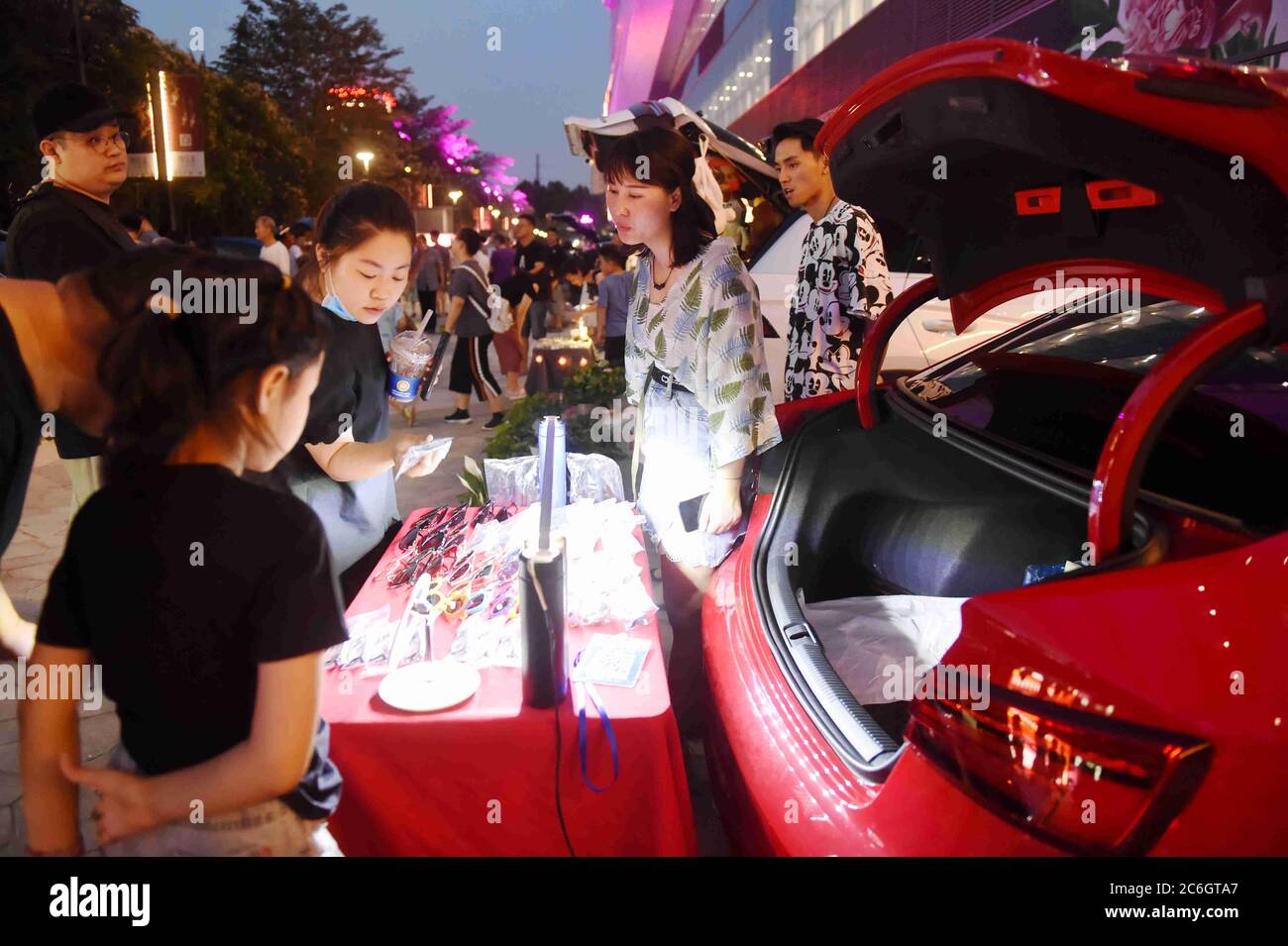 Customers wander and purchase at a trunk bazaar, where limousines ...