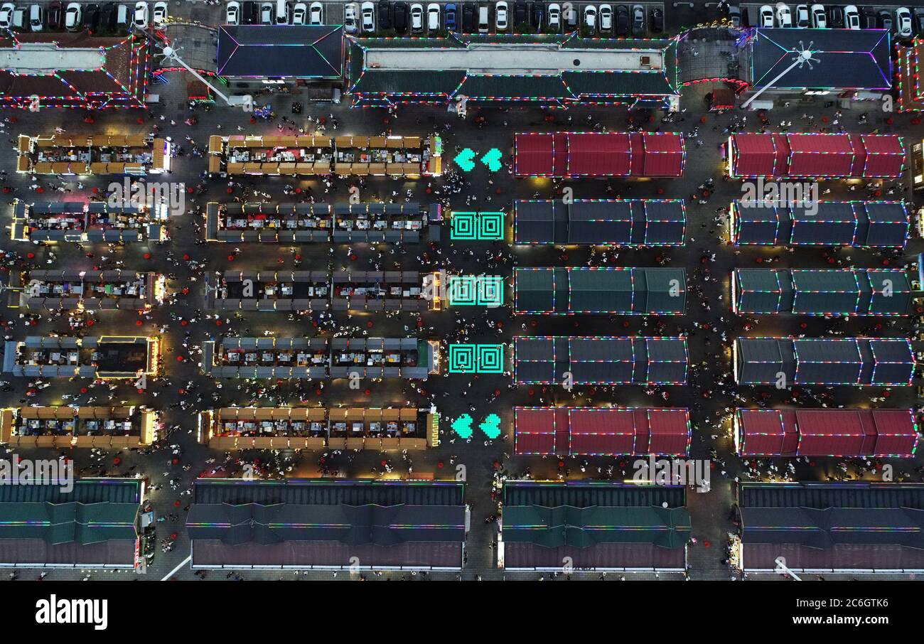 An aerial view of tourists wandering among and buying food from snack ...
