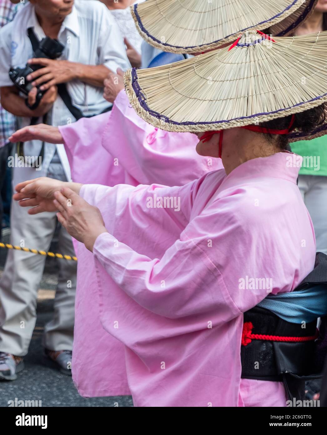 Folk dancers in colorful yukata and amigasa straw hat dancing in ...
