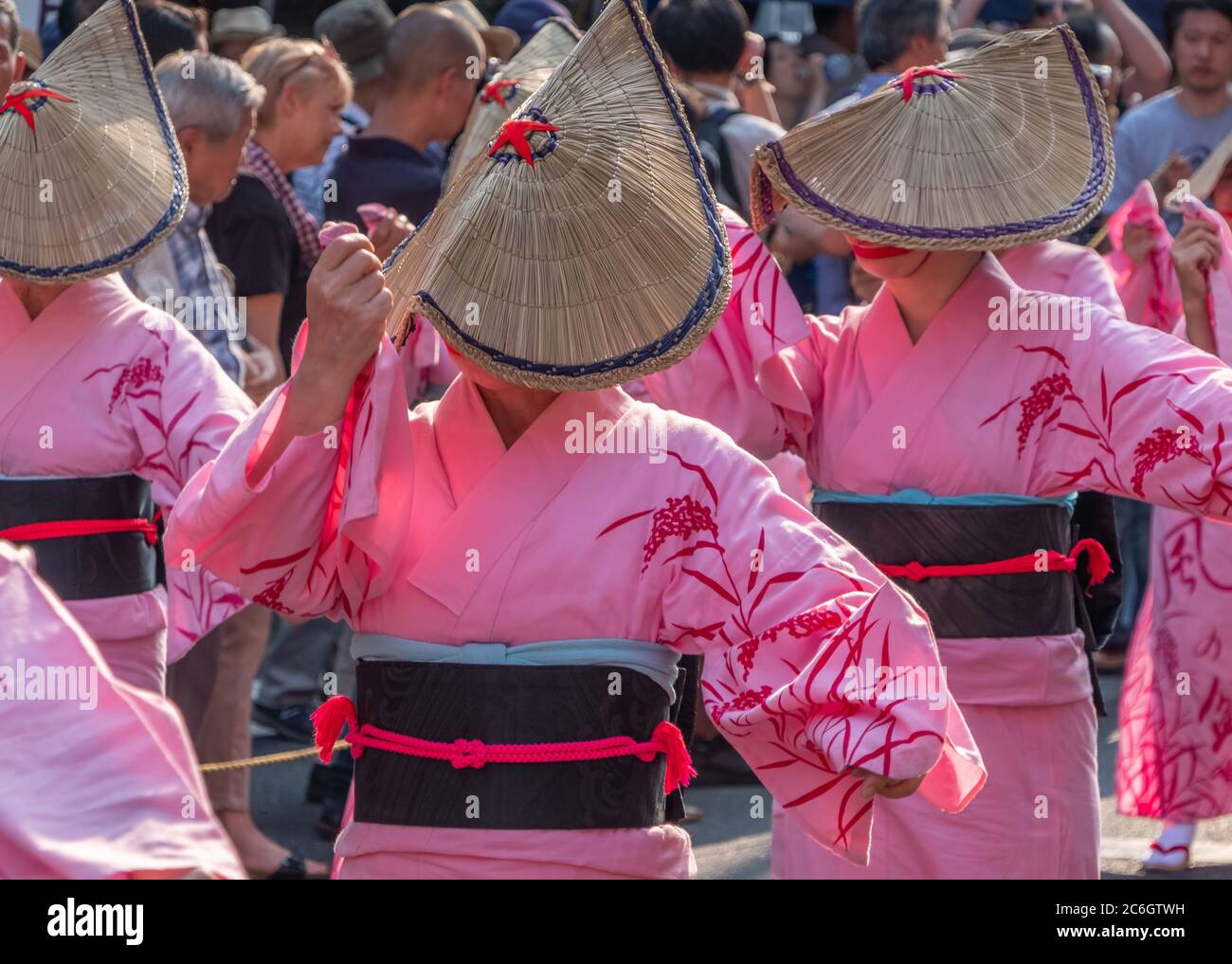 Folk dancers in colorful yukata and amigasa straw hat dancing in ...