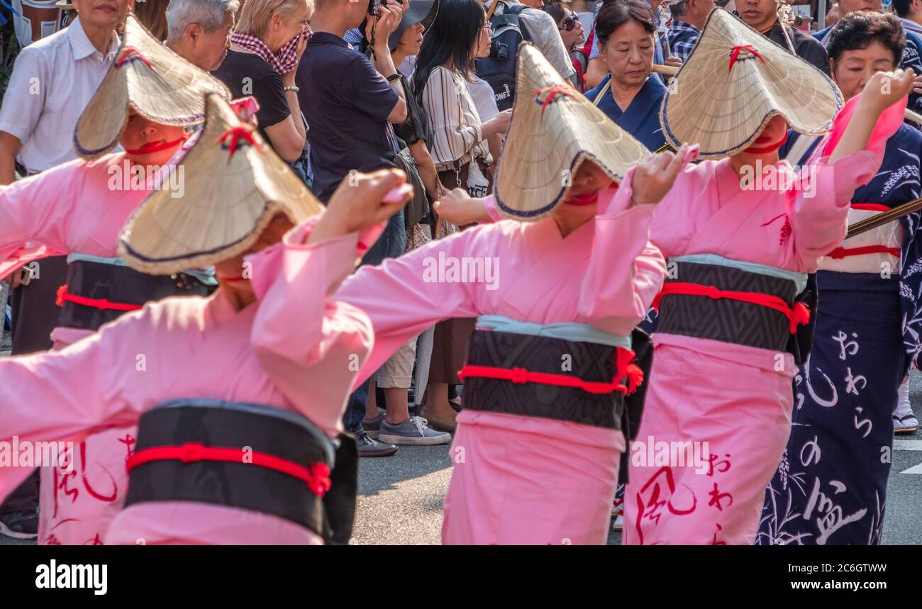 Folk dancers in colorful yukata and amigasa straw hat dancing in ...