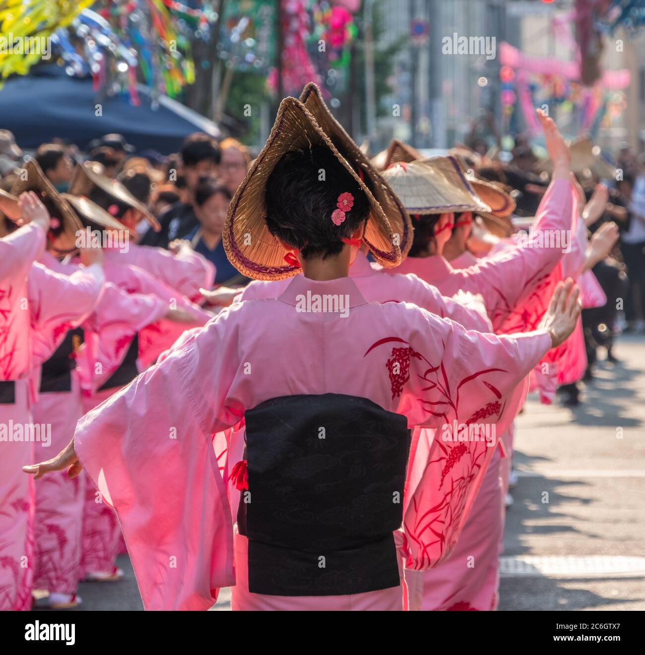 Folk dancers in colorful yukata and amigasa straw hat dancing in ...