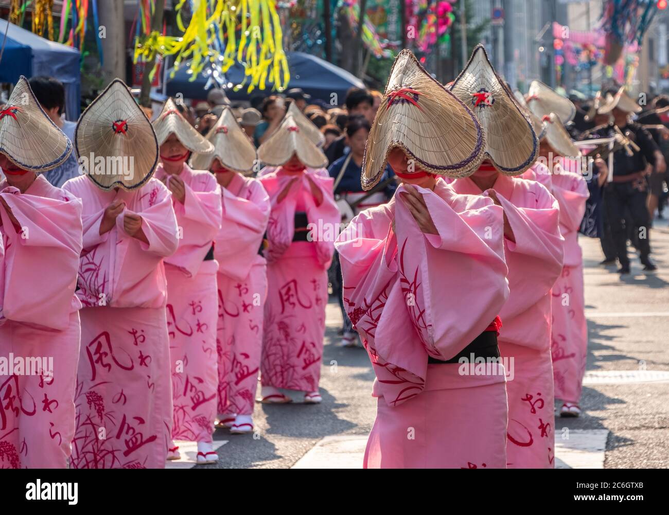 Folk dancers in colorful yukata and amigasa straw hat dancing in ...