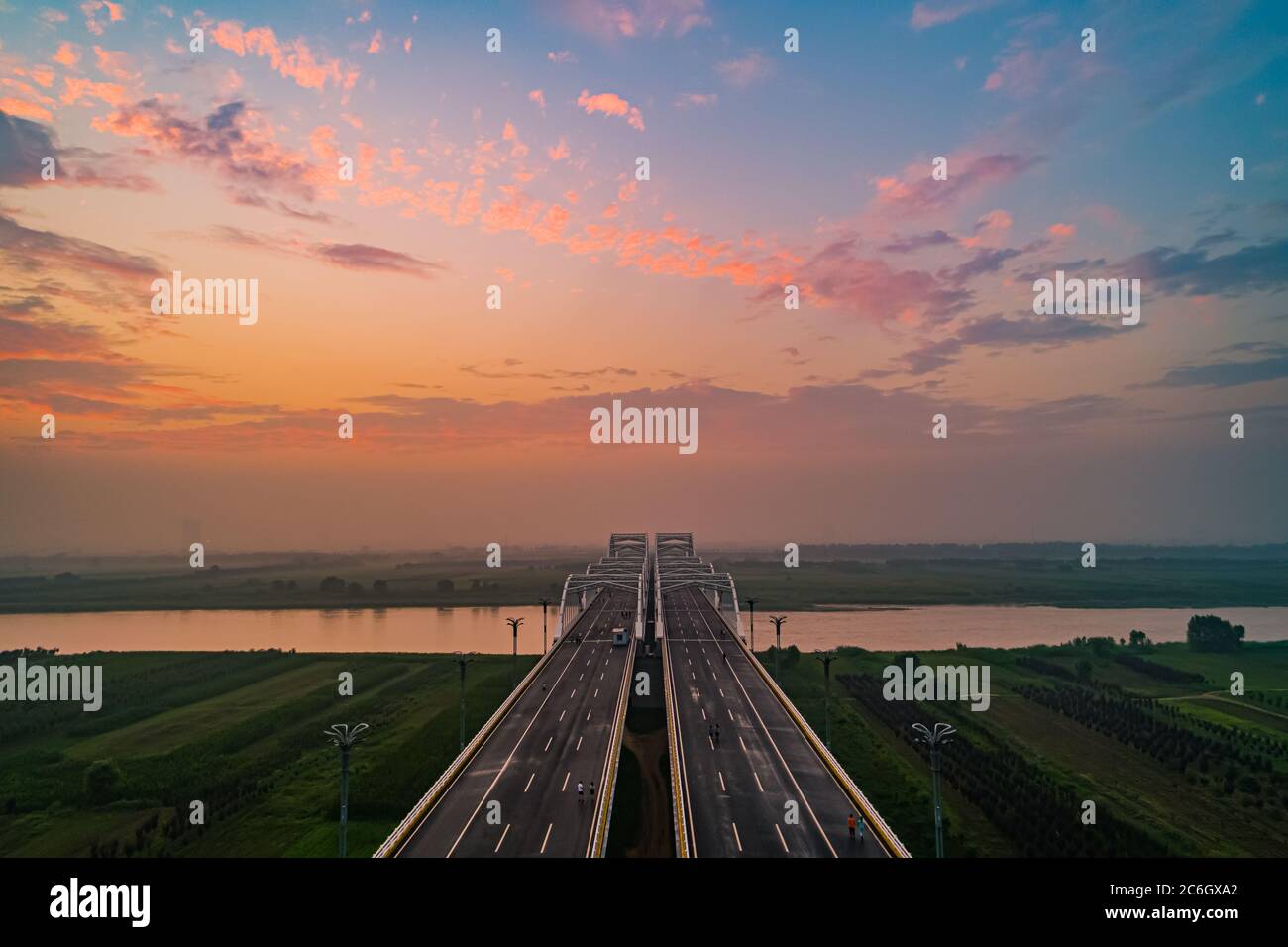 Sunset paints the skyline into golden yellow and purple after a ...