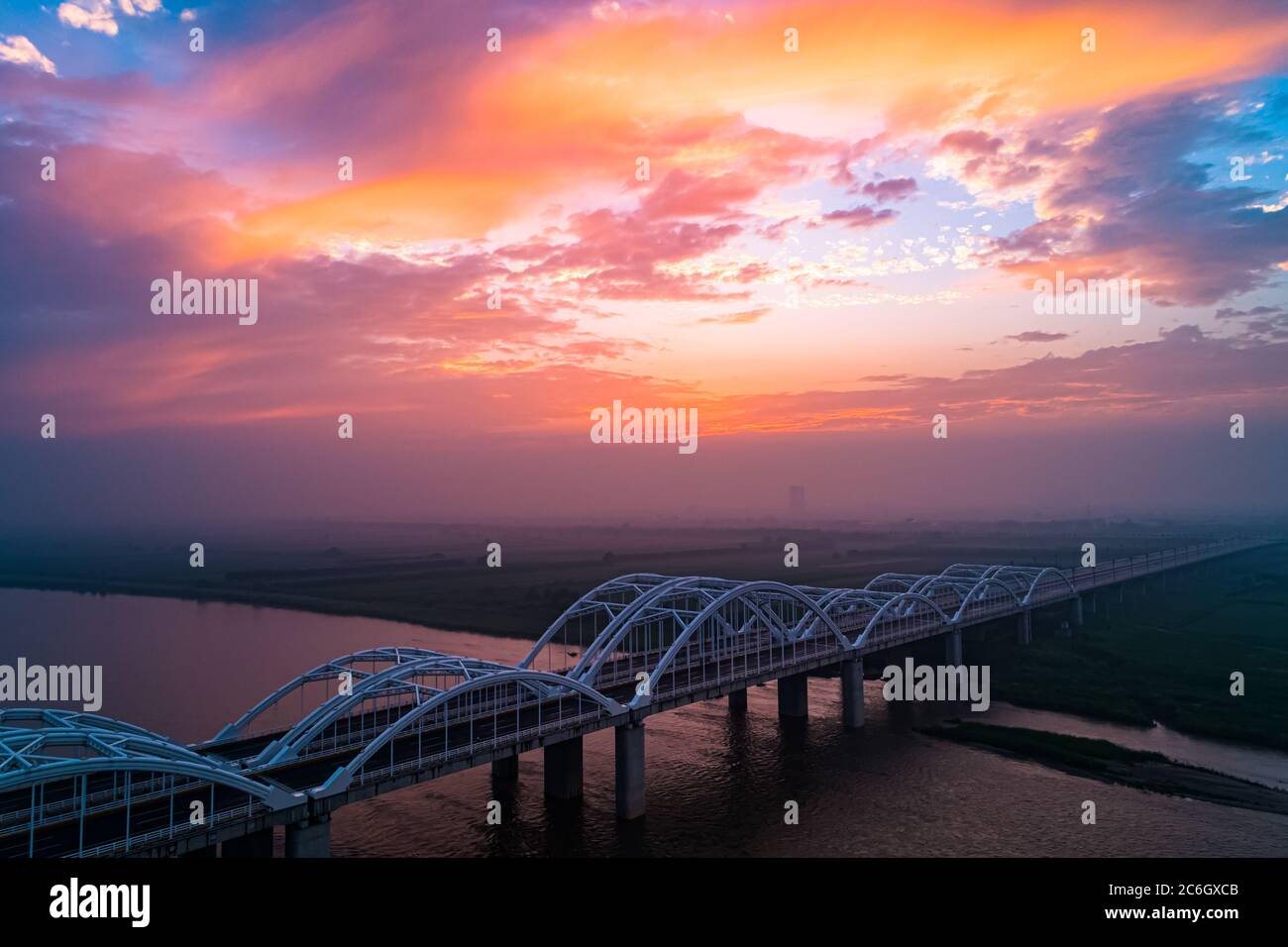 Sunset paints the skyline into golden yellow and purple after a ...