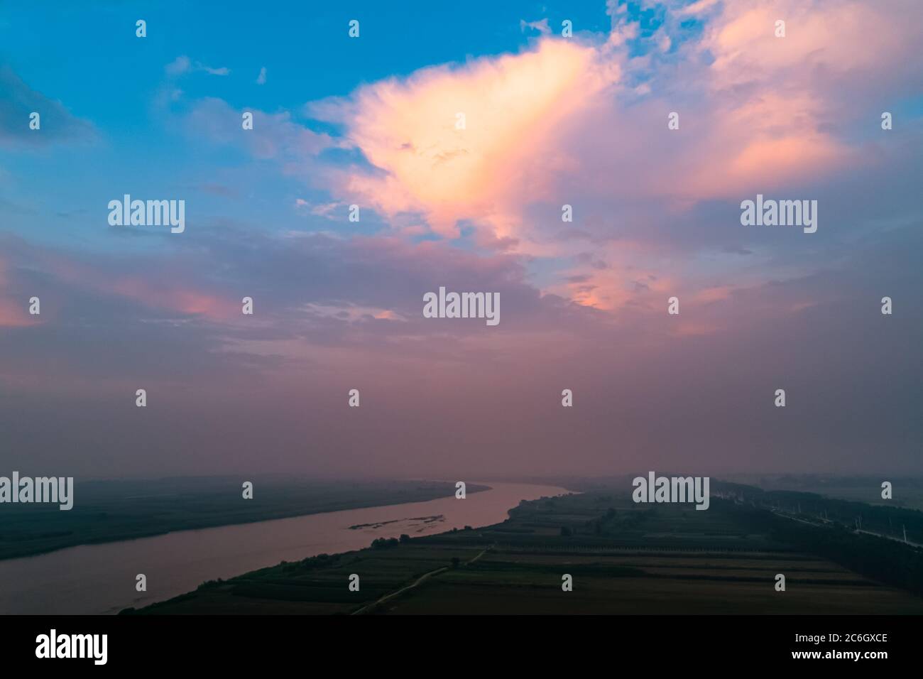 Sunset paints the skyline into golden yellow and purple after a ...