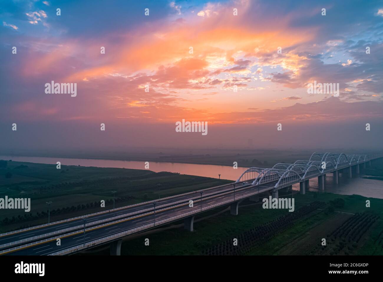 Sunset paints the skyline into golden yellow and purple after a ...