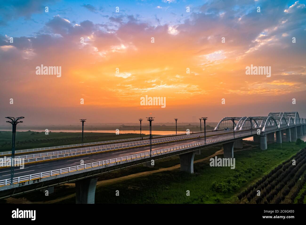 Sunset paints the skyline into golden yellow and purple after a ...