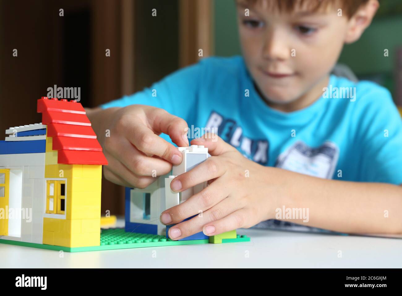 Boy builds a house with building blocks (Model released Stock Photo - Alamy