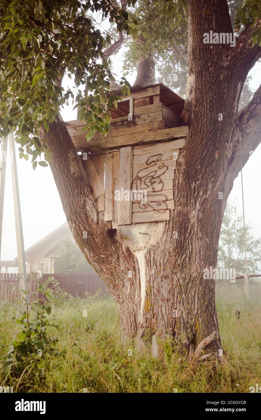 Cute small tree house for kids on backyard Stock Photo - Alamy