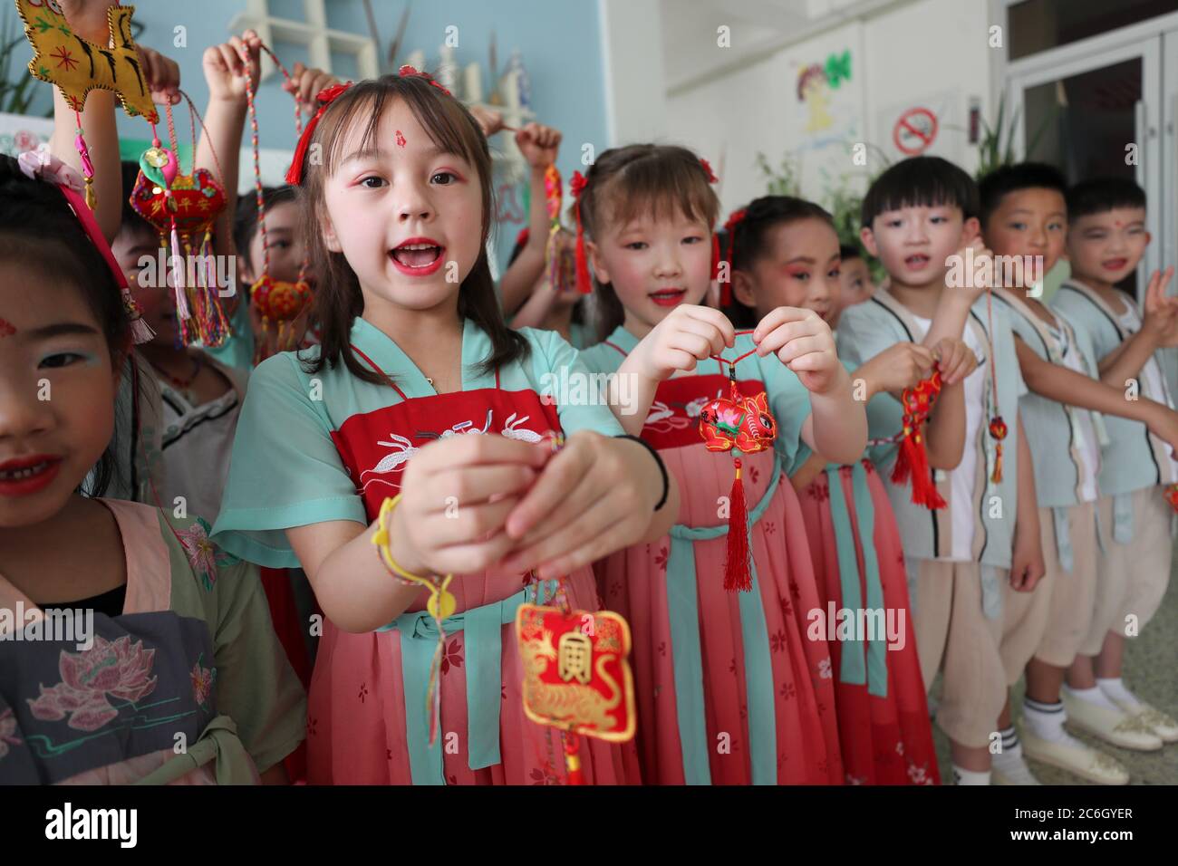 Dressed in ancient Chinese clothes, children at a local kindergarten ...