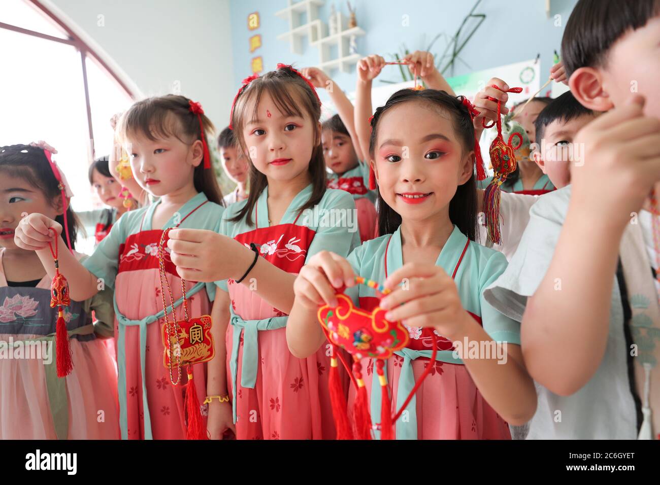 Dressed in ancient Chinese clothes, children at a local kindergarten ...