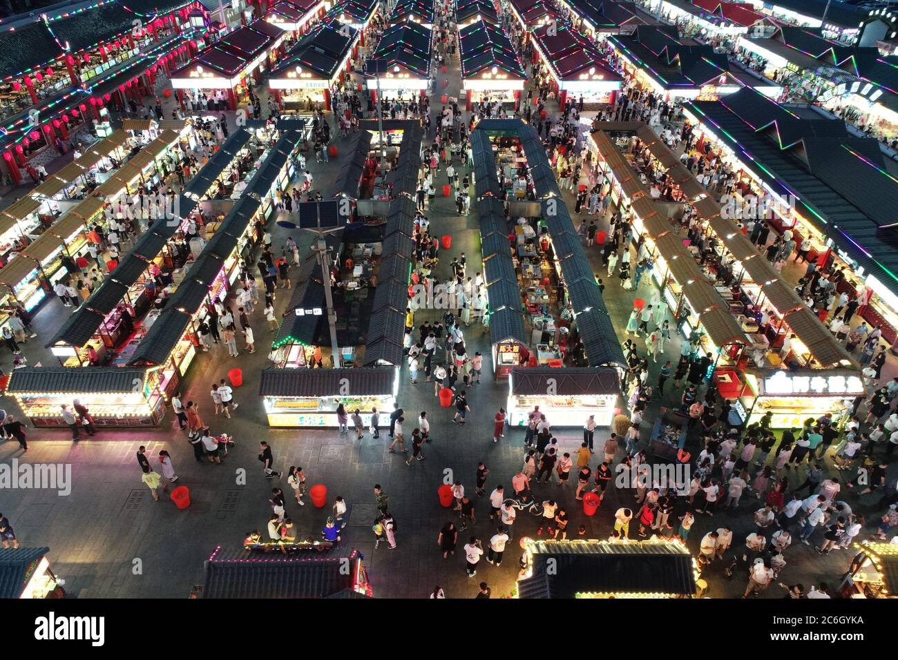 An aerial view of tourists wandering among and buying food from snack ...