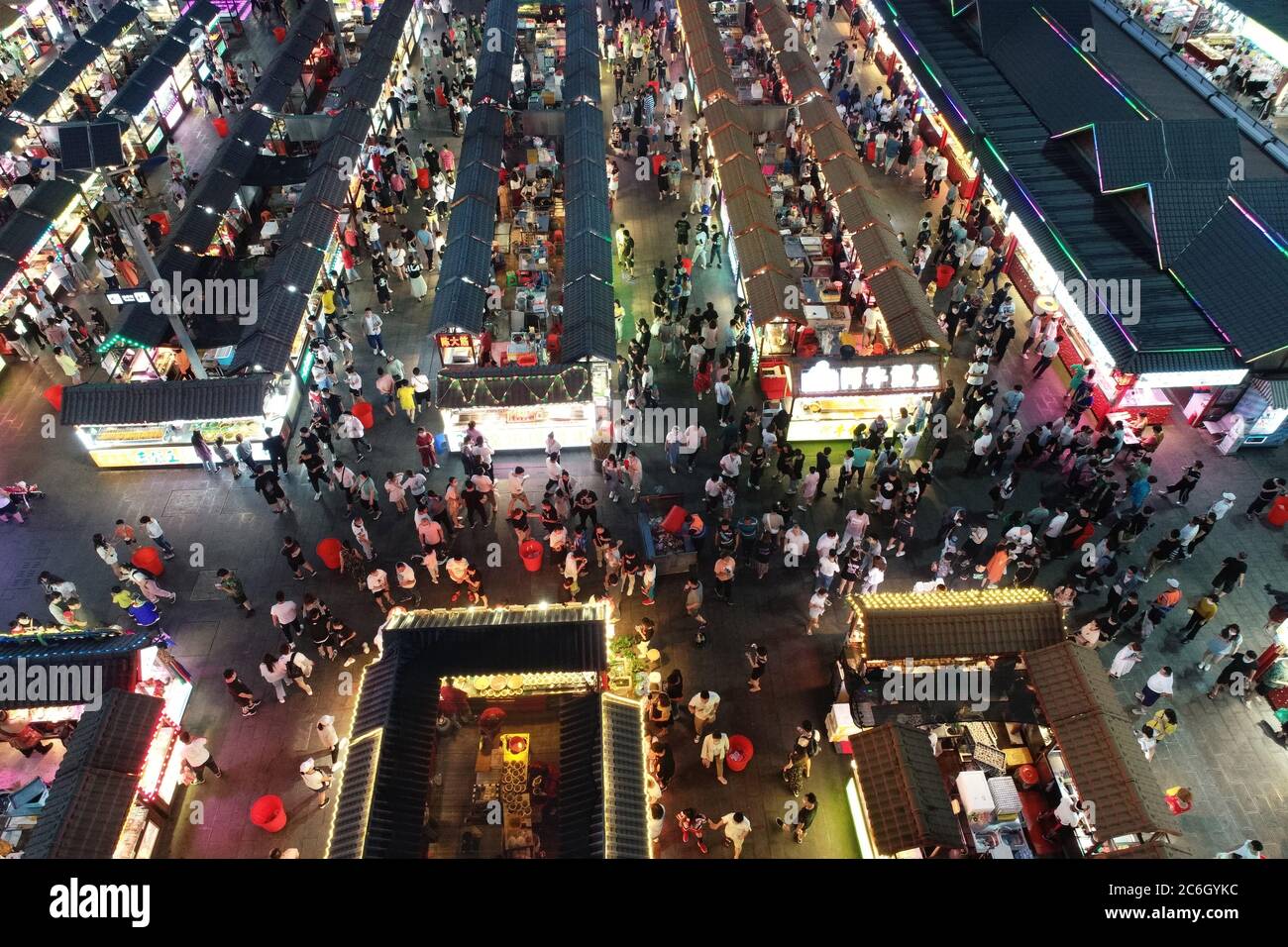 An aerial view of tourists wandering among and buying food from snack ...