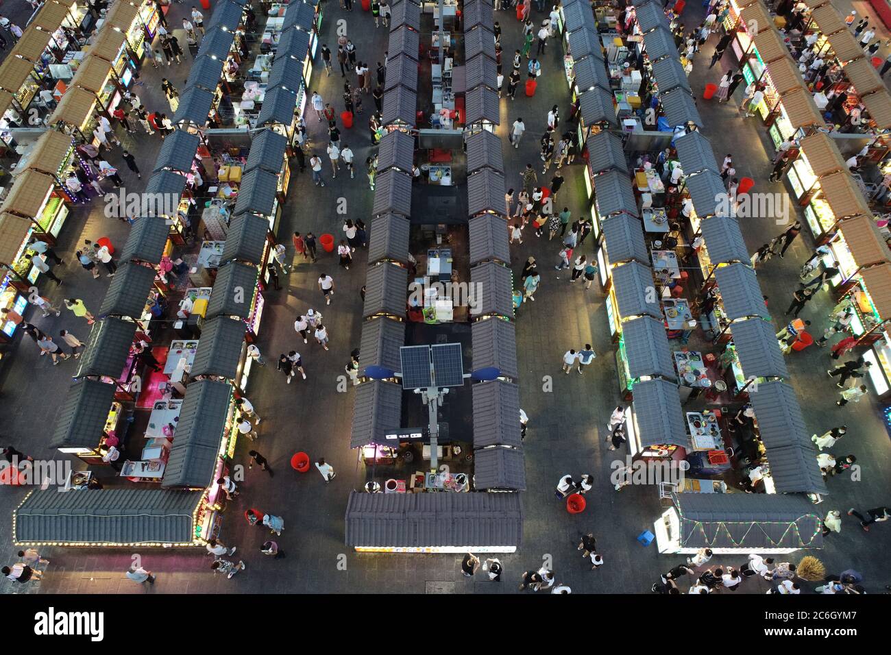 An aerial view of tourists wandering among and buying food from snack ...